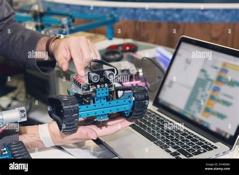 Model Of A Robot In The Hands Of A Teacher During A Robotics Lesson