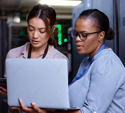 female programmers run diagnostics in server room repair teamwork