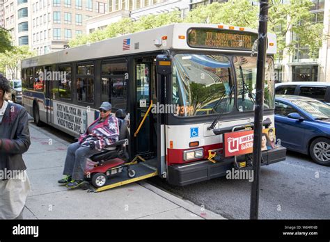 Chicago Cta Accessible Bus With Woman On Motorised Wheelchair Exiting Front Door Ramp Chicago Il