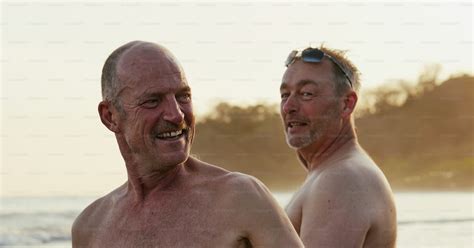 Two Older Men Standing In The Water At The Beach Photo Beach Image On