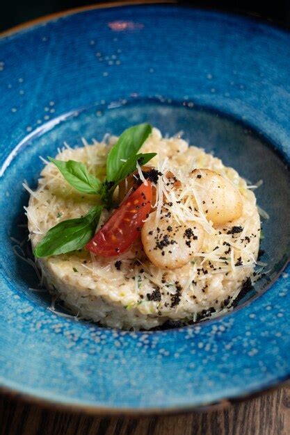 Premium Photo Risotto With Scallops On A Blue Plate With Parmesan