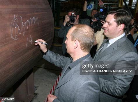 Russian President Vladimir Putin Signs An Autograph Next To Russian
