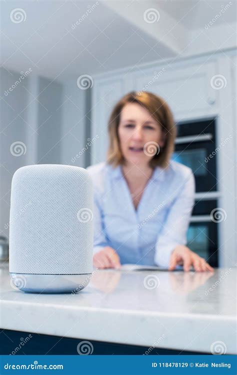 Woman In Kitchen Asking Digital Assistant Question Stock Image Image