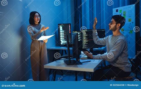 Trainee Developer Hand Up To Ask Speaker About Software Coding Project Presentation At Night In