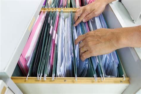 Hand Of Man Search Files Document In A File Cabinet In Work Office Stock Photo Image Of