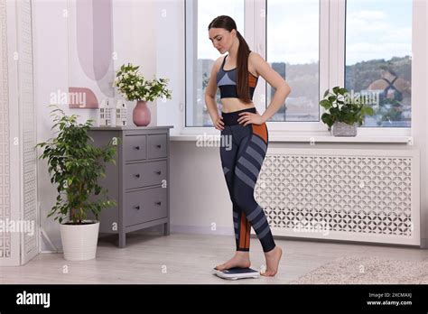 Woman Stepping On Floor Scale At Home Stock Photo Alamy