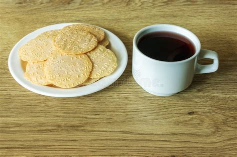 chips with the lithuanian text taler and tea on the table stock image
