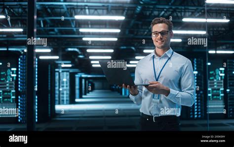 Successful Data Center It Specialist Using Laptop Computer Server Farm Cloud Computing Facility