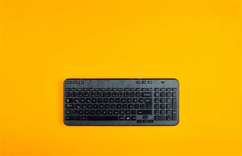 Black Computer Keyboard On Yellow Background With Copy Space Stock