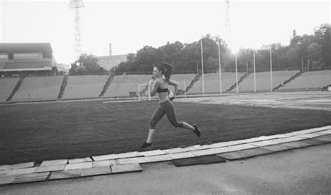 Premium Photo Slim Athletic Woman With Dumbbells In The Stadium Sporty Sexy Girl With Flat