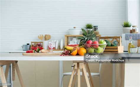 과일 파인애플 바나나 석류 빨간색과 녹색 사과의 아무도와 배경 복사 공간이 아늑한 흰색 깨끗한 부엌에서 나무 테이블에 장식 된 좋은 건강에 대한 건강한 음식과 인테리어 컨셉