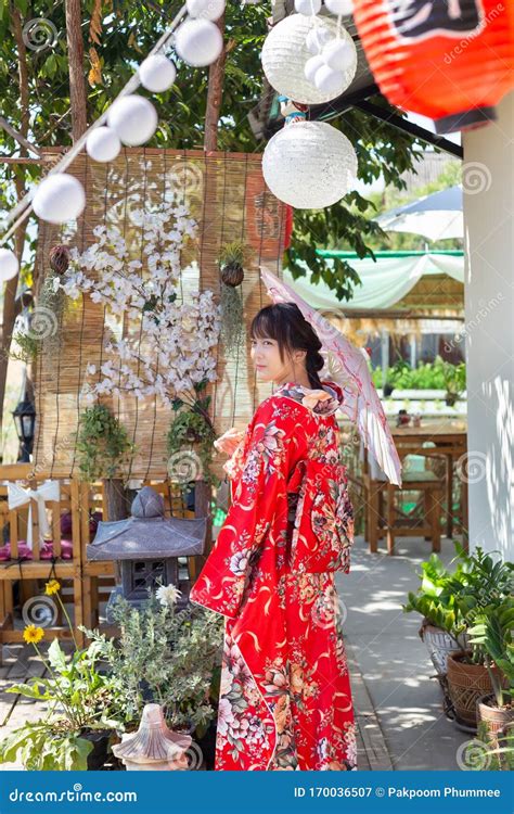 The Girl Is Wearing A Red Traditional Kimono Which Is The National