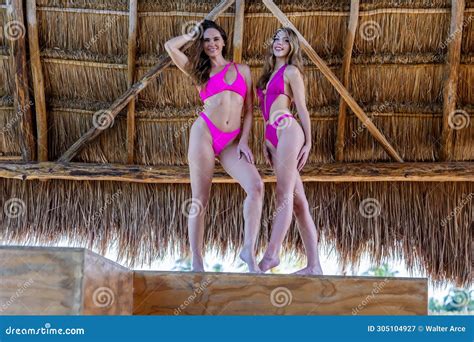 Caribbean Elegance Twin Goddesses Grace A Beach Hut In Pink Bikinis