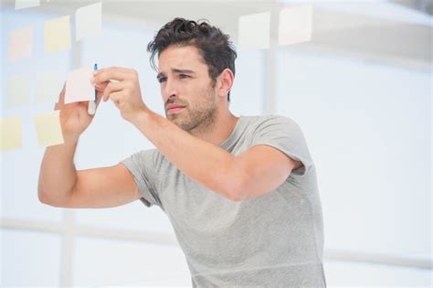 Premium Photo Man Writing On Sticky Notes