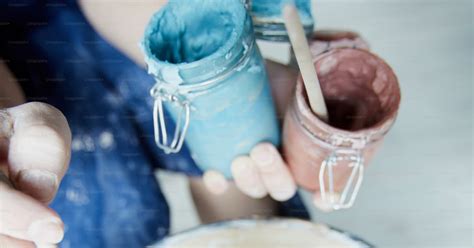 도자기 바퀴의 회전하는 주전자 위에 창의적인 도예가의 손에 파란색으로 된 붓 사진 Unsplash의 러시아 이미지