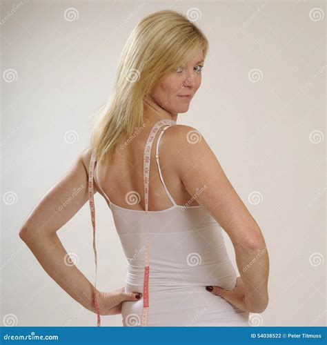 Woman Using A Tape Measure To Check Her Size Stock Photo Image Of Skimpy Beauty 54038522