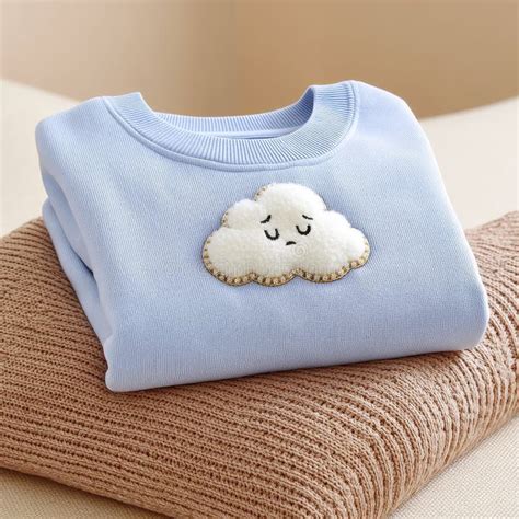 Pale Blue Knit Sweater With Embroidered Cloud Detail Stock Illustration
