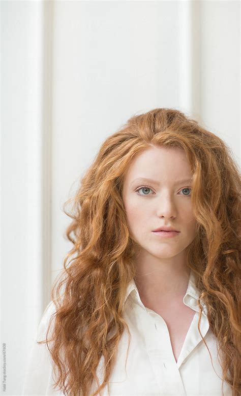 Beautiful Ginger Girl In Front Of White Vintage Wall De Stocksy