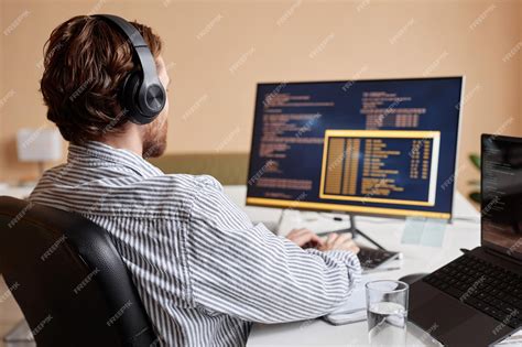 Premium Photo Male Computer Programmer Coding And Wearing Headphones
