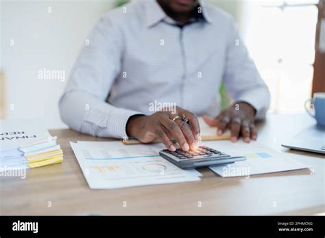 Middle Age Man American African Using Calculator For Calculating And Laptop Computer With