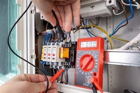 Technician Holding Probes For Circuit Testing With Multimeter Stock