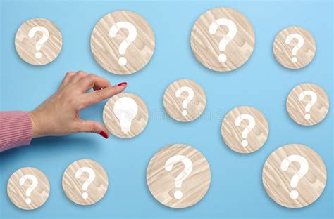 The Hand Holds A Wooden Plate With An Electric Lamp And Dice With Question Marks The Concept Of