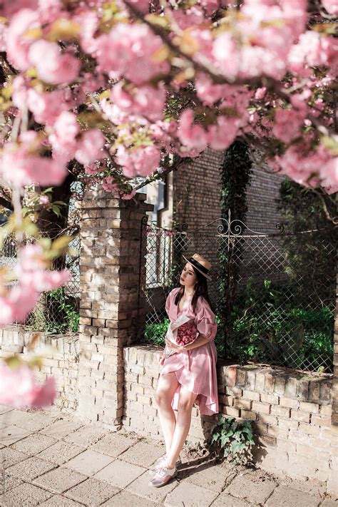 Young Woman Walking Under Sakura Tree By Stocksy Contributor Jovana Rikalo Stocksy