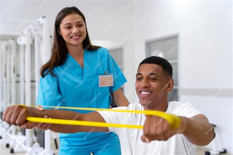 Free Photo Medical Assistant Helping Patient With Physiotherapy Exercises