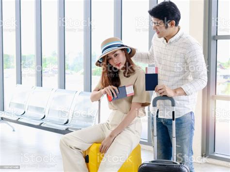 Asian Young Traveler Lover Couple Holding Passport And Boarding Pass