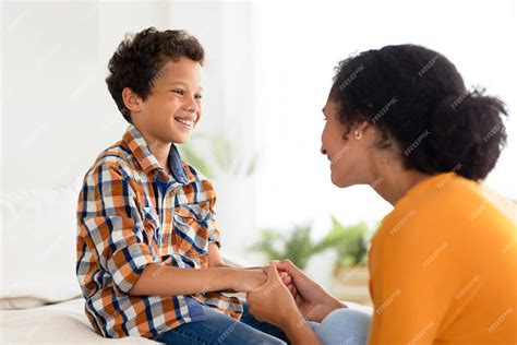 Premium Photo Happy Mother And Son Talking And Enjoying Conversation At Home