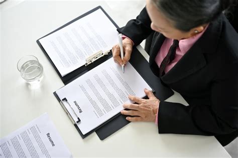 Premium Photo Top View Of A Female Recruiter Reading A Candidate S Resume During A Job Interview