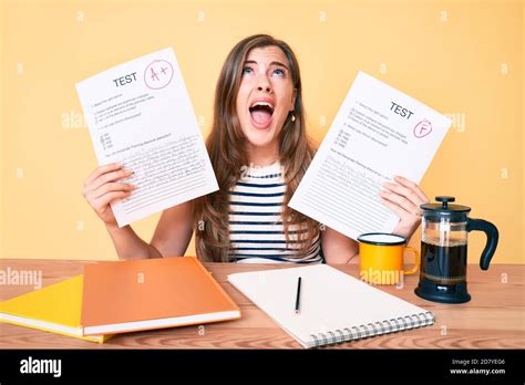 Young Beautiful Caucasian Woman Showing Failed And Passed Exam Sitting