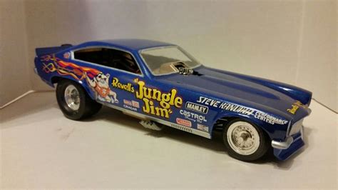 A Blue Toy Car With An Advertisement On The Front And Back Side Sitting On A White Surface