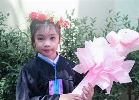 Premium Photo Portrait Of Innocent Girl Holding Prop While Standing