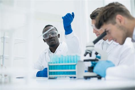 Premium Photo Rear View A Group Of Scientists At The Laboratory Table Science And Technology