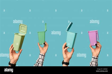 Four Hands With Plastic Trash Containers On Clean Blue Background Planet Ecology Concept Stock