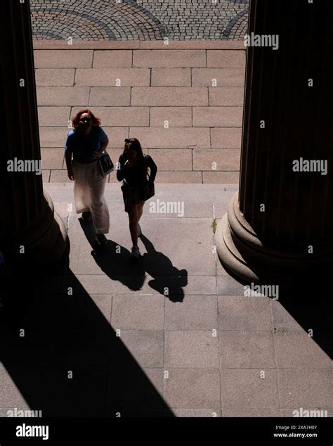 A Woman And A Girl Stand By Pillars And Columns Of A Building Stock Photo Alamy