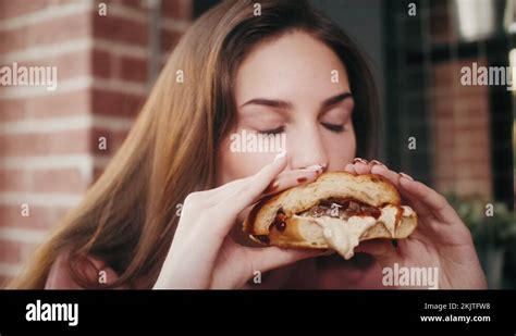 Beautiful Student Girl Eating Burger In Restaurant Enjoying Delicious Hamburger Stock Video