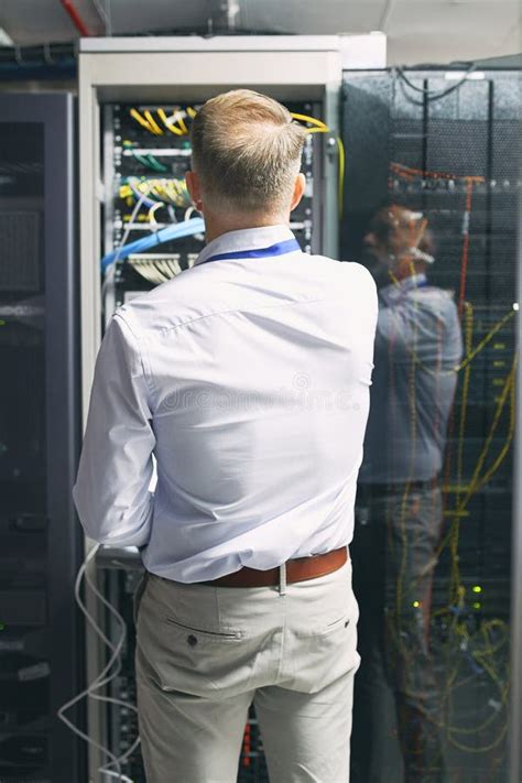 Connecting To The Main Server Rearview Shot Of A Mature Man Working In