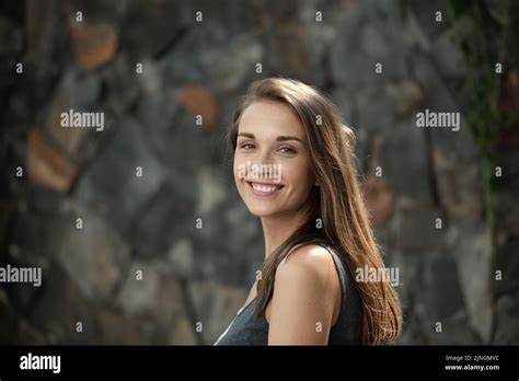Portrait Of Naturally Beautiful Girl Smiling At Camera On Stone Background Stock Photo Alamy