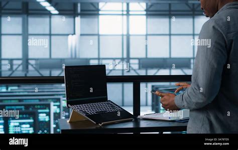 Admin Arriving In Data Center Using Artificial Intelligence Tech On Tablet And Laptop Man In