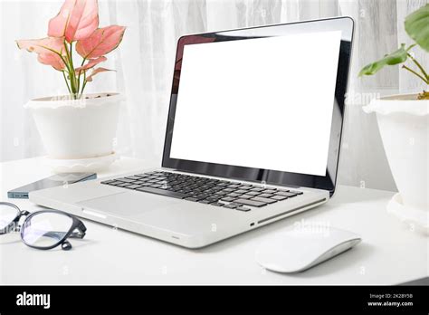 Mock Up Laptop Computer Blank White Screen Eyeglasses And Smartphone White Table Stock Photo