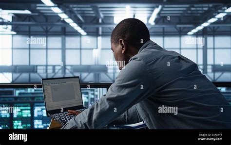 Technician In Data Center Using Laptop Adjusting Power Management