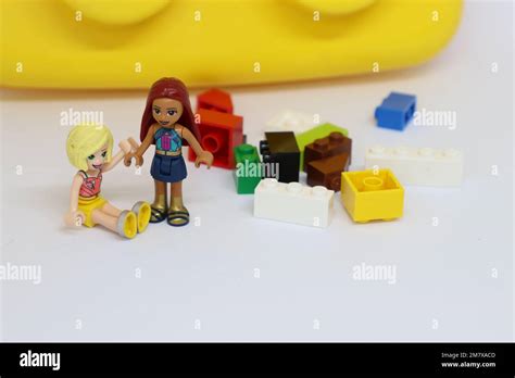 Lego Mini Figures Next To A Pile Of Lego Blocks With A Large Block In