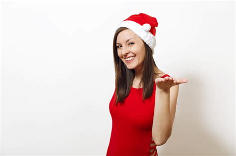 매우 백인 행복 여자 빨간 드레스와 카메라 찾고 크리스마스 모자를 입고 매력적인 미소로 팜 흰색 배경에 고립에 복사 공간을 잡고 산타 소녀입니다 새 해 휴일 2018 개념