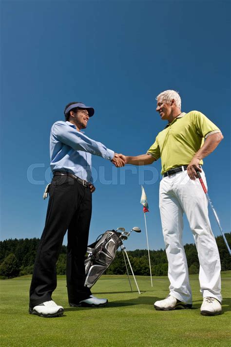 Golfer And Caddy Shaking Hands Stock Image Colourbox