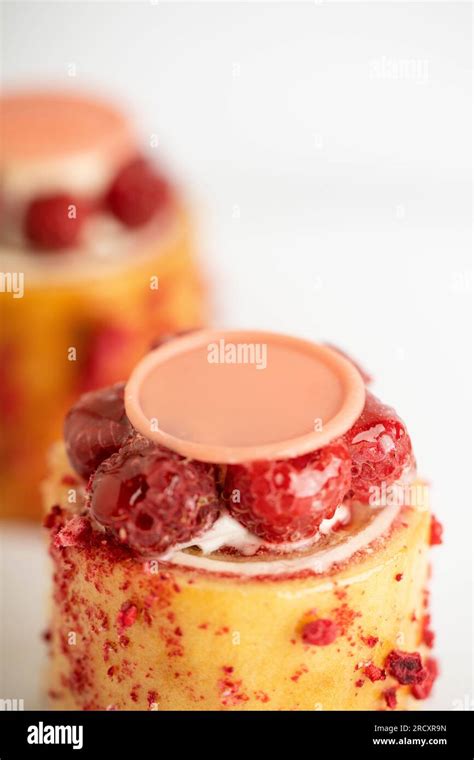 A Delicious Dessert Of Raspberry Pudding Topped With Luscious Cream And A Delicious Dessert Of Raspberry Pudding Topped With Luscious Cream And