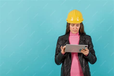 Premium Photo Architect Girl Is Looking At Planshet Computer In Hand On Blue Backgroundxdxa