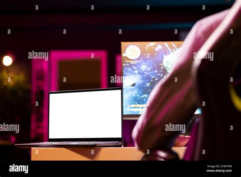 Mockup Laptop Next To Man Playing High Fps Singleplayer Videogame With