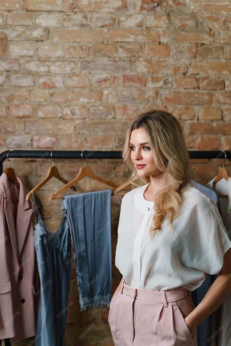 Premium Photo Young Woman Fashion Designer And Clothing Rack With